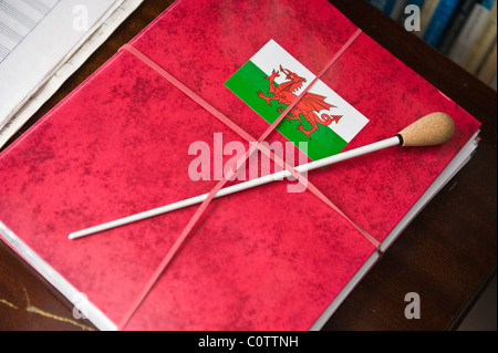 Welsh conductor's baton on file of manuscripts with red dragon flag ...