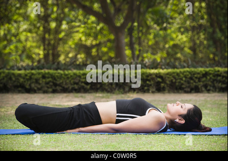 young woman doing fish pose at yoga studio Stock Photo - Alamy