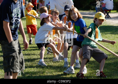 Second-grade boys and girls pull on rope during tug-of-war at ...