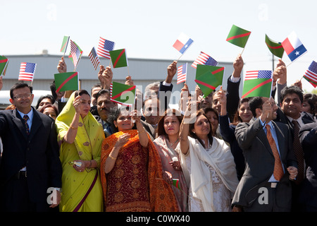 Ismaili Muslims wave small Ismaili and Texas flags while greeting the ...