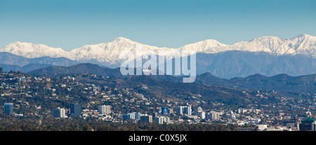 Skyline of Los Angeles after a winter storm featuring snow on mountains ...