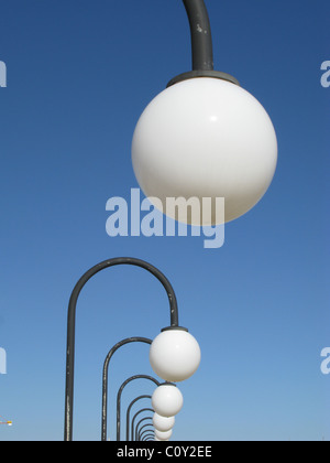 a long row line of street lights and blue sky Stock Photo - Alamy