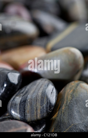 Close-up of pebbles in different sizes, colors and structures with wood ...