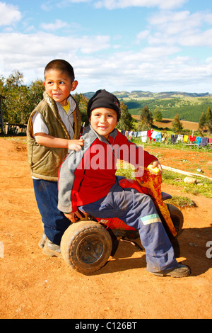 Two boys playing with a tricycle, Mapuche Indians, near Concepción ...