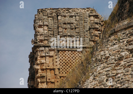 Close up of ancient Mayan carvings depicting heads and geometric shapes ...
