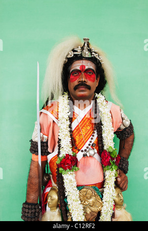 Portrait of a sadhu standing on one leg on the support of swing at Maha ...