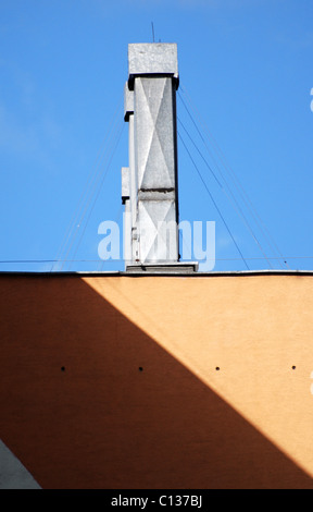 Detail of the smoking chimney of an ancient brick and stone building ...