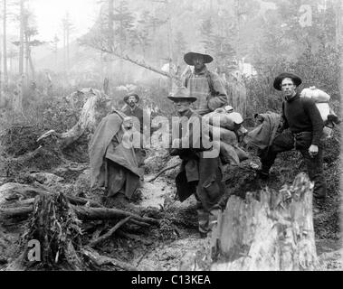 Four prospectors posed on trail in Alaska during the Yukon gold rush in ...