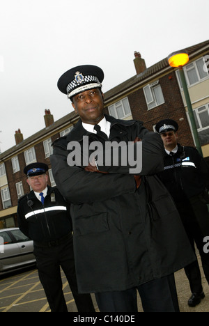 Black Police Inspector standing with community support officers in UK ...