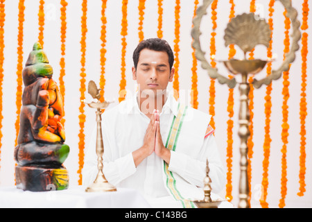 Bridegroom praying Lord Ganesha during South Indian wedding ceremony ...