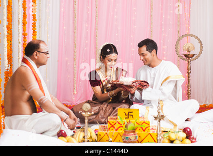 Bridegroom giving a sari to the bride at the South Indian wedding ...