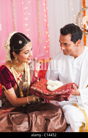 Bridegroom giving a sari to the bride at the South Indian wedding ...