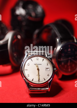 Clocks on a red metal background with free space Stock Photo - Alamy