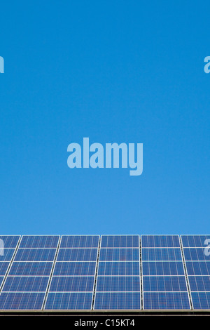 Solar panels on blue sky background Stock Photo - Alamy