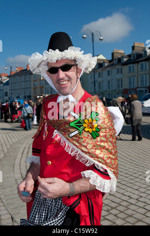 man dressed in traditional welsh folk clothing playing the violin ...