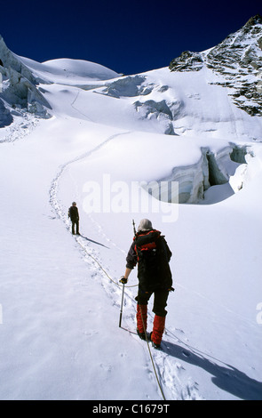 Two mountaineers ascending Stock Photo - Alamy
