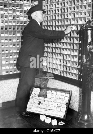 A black-and-white photograph of a letter carrier delivering mail by ...