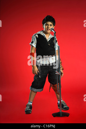 A rapper performing with a red background Stock Photo - Alamy