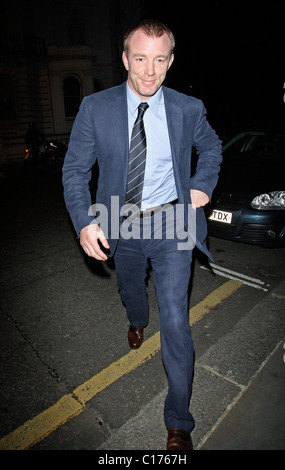 Guy Ritchie in a blue suit and brown shoes arrives at a restaurant in ...
