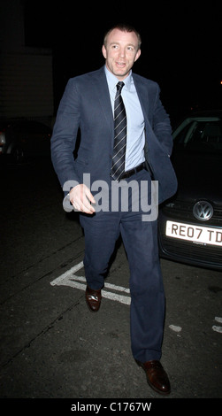 Guy Ritchie in a blue suit and brown shoes arrives at a restaurant in ...