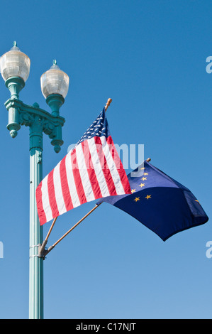 The flags of the Alaska state and United States of America waving in ...
