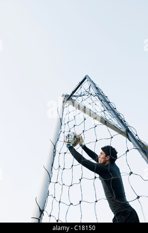 Low angle view of a goalie catching a ball Stock Photo - Alamy