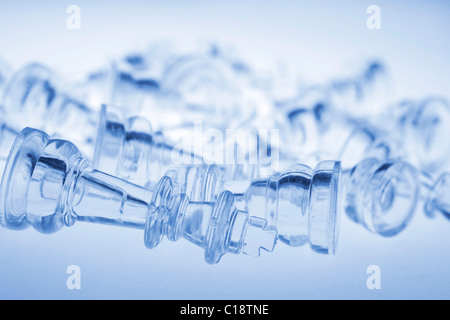 Chess with game pieces made of glass, queen, king, pawn and game board ...