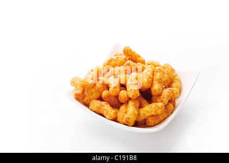 Peanut flips, in a white bowl. Also known as Bamba, peanut puffs or ...