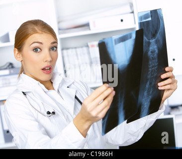 Portrait of confused female doctor examining x-ray picture Stock Photo ...