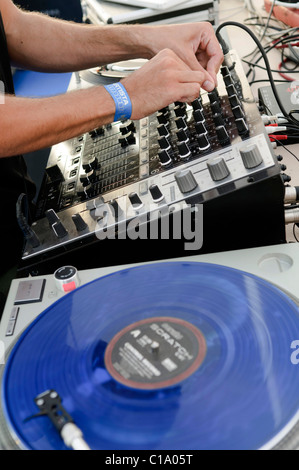 Party dj scratches vinyl record with music on turn table record player ...