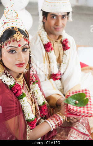 Happy Indian bride holding betel leaf, Bengali bride in traditional ...