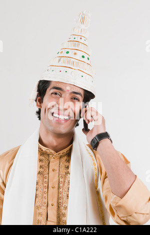 Bridegroom wearing a topor and talking on a mobile phone Stock Photo ...