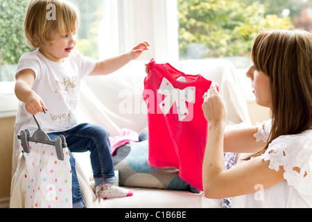 Mother and child choosing clothes to wear Stock Photo - Alamy