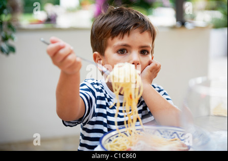 Boy eating Spaghetti with Hands Stock Photo - Alamy