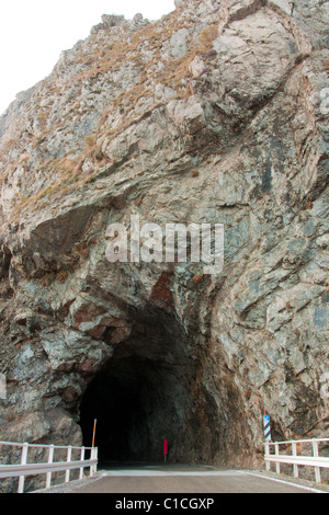 Close-up of a sandstone cave entrance carved into a cliff face, with ...