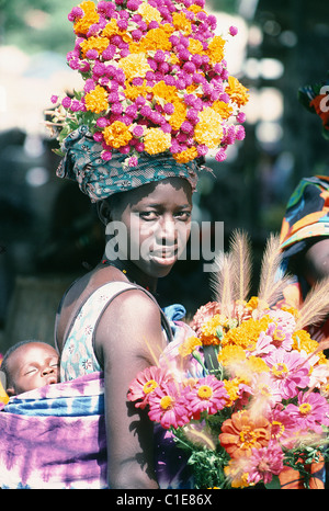 Senegal, Dakar region, Kermel market, woman carrying flowers on sale on ...