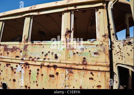 Abandoned bus with rusty bullet holes, Mojave desert, California Stock ...