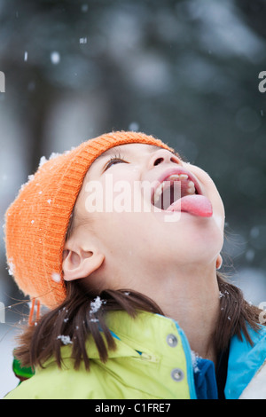 Mixed Race girl catching snowflakes on tongue Stock Photo - Alamy