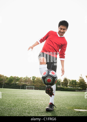 Man practicing soccer on field Stock Photo - Alamy