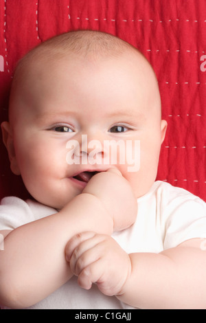 Caucasian baby biting finger Stock Photo - Alamy