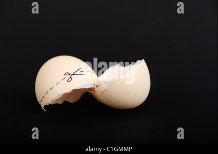 Stock photo of cracked egg shells with a cut here mark across the shell ...