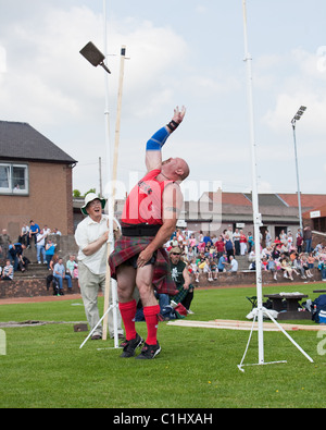 Man throwing the weight over the bar, a traditional style of game ...