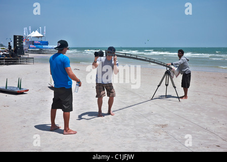 Camera boom. Beach photographer using a camera boom for elevated views ...