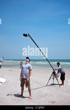 Camera boom. Beach photographer using a camera boom for elevated views ...