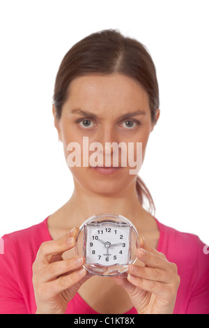 Female hands with alarm clocks on light background Stock Photo - Alamy