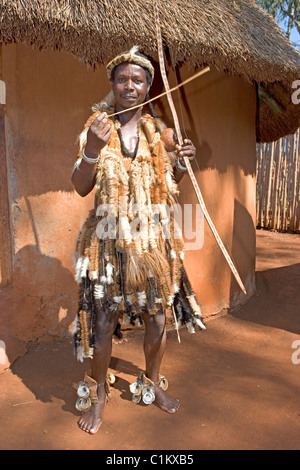 A Zulu man in traditional Zulu outfit with a headpiece made of ...