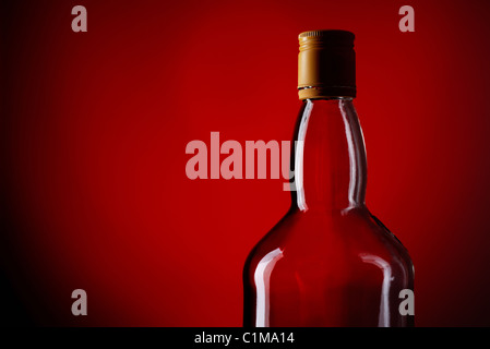 bottle of whiskey on deep red background Stock Photo - Alamy