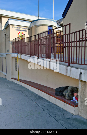 A homeless man sleeping by a local church Stock Photo - Alamy