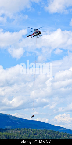 Rescue helicopter rescuing person by airlifting dangling on rope Stock ...