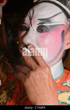 Chinese opera performer smoking backstage in Bangkok, Thailand Stock ...